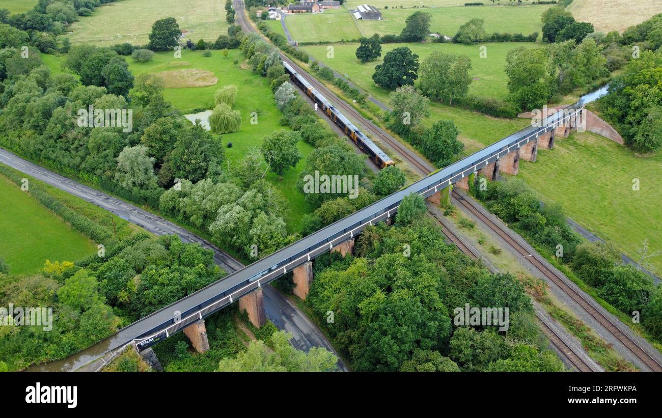 A West Midlands Railways train passes under the historic Edstone ...