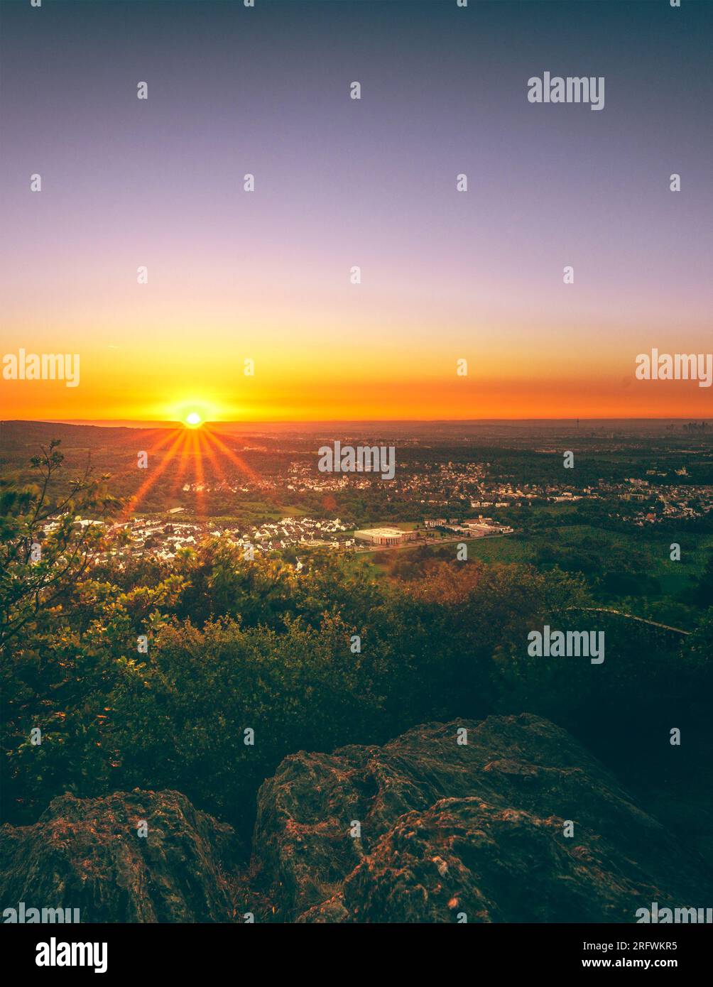 Backlit shot on a mountain with a view of the landscape, sunset, forest ...