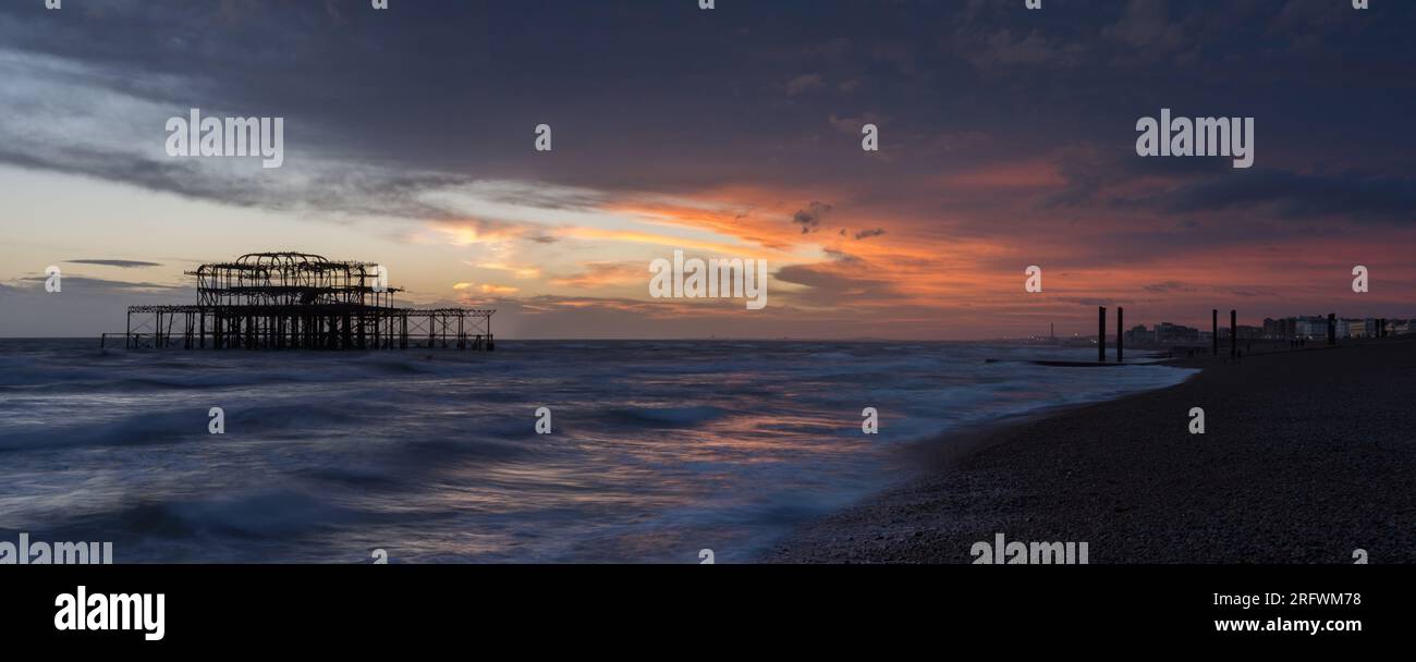 Brighton Old Pier and beach at sunset panorama Stock Photo - Alamy