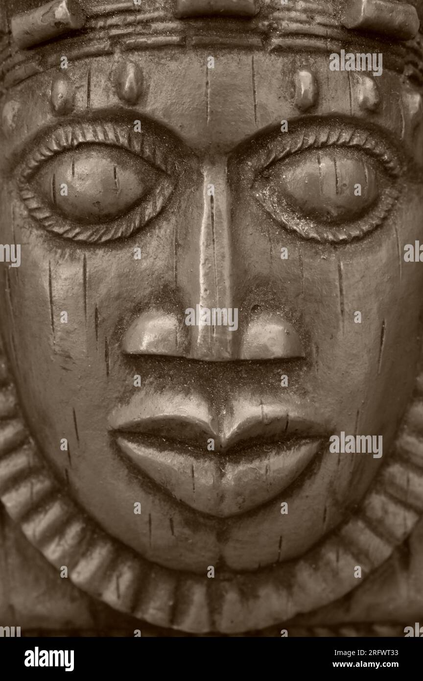 Sepia image of African tribal mask with large eyes and mouth and wide ...