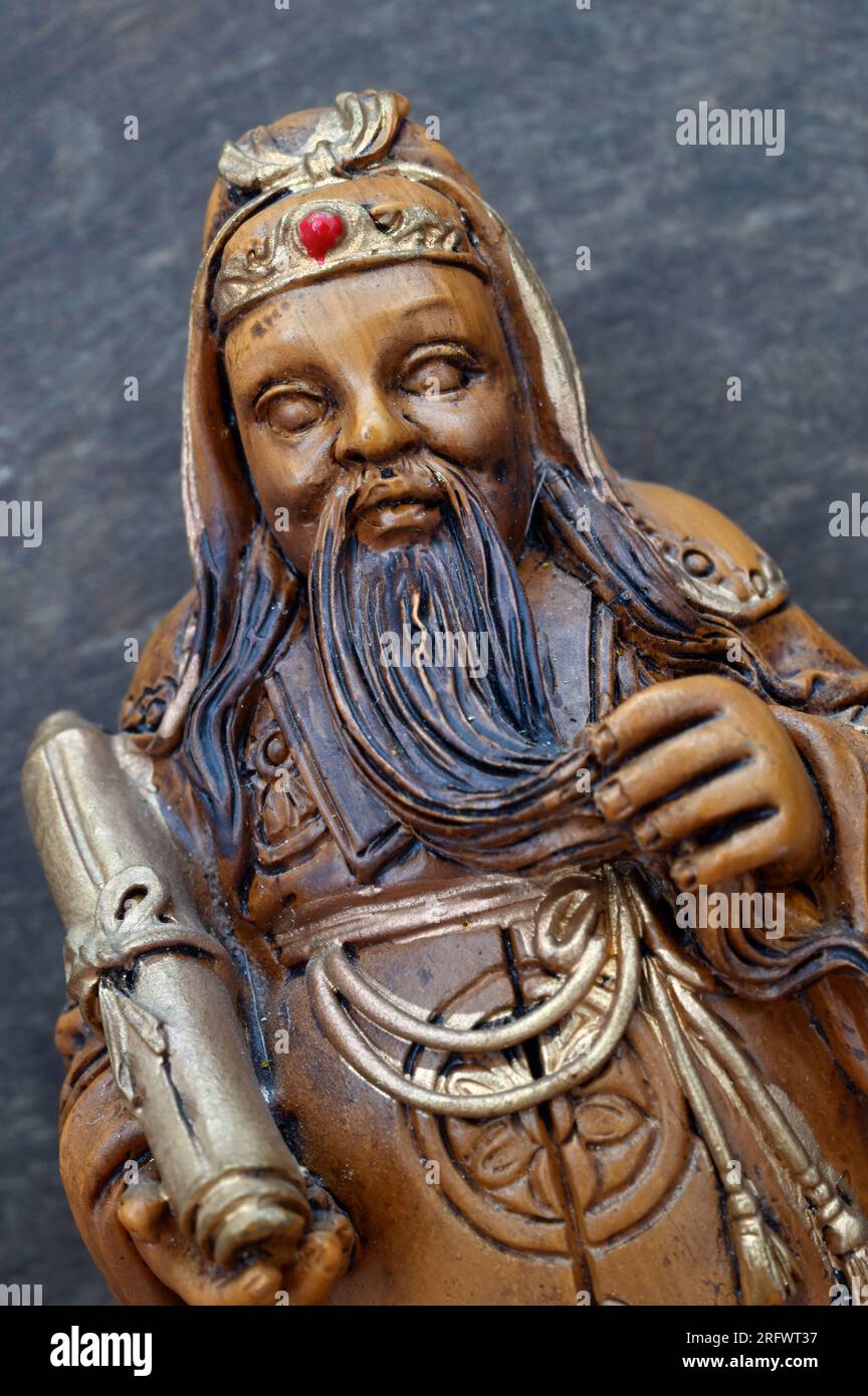 Model of Chinese philosopher Confucius in robe holding scroll Stock ...