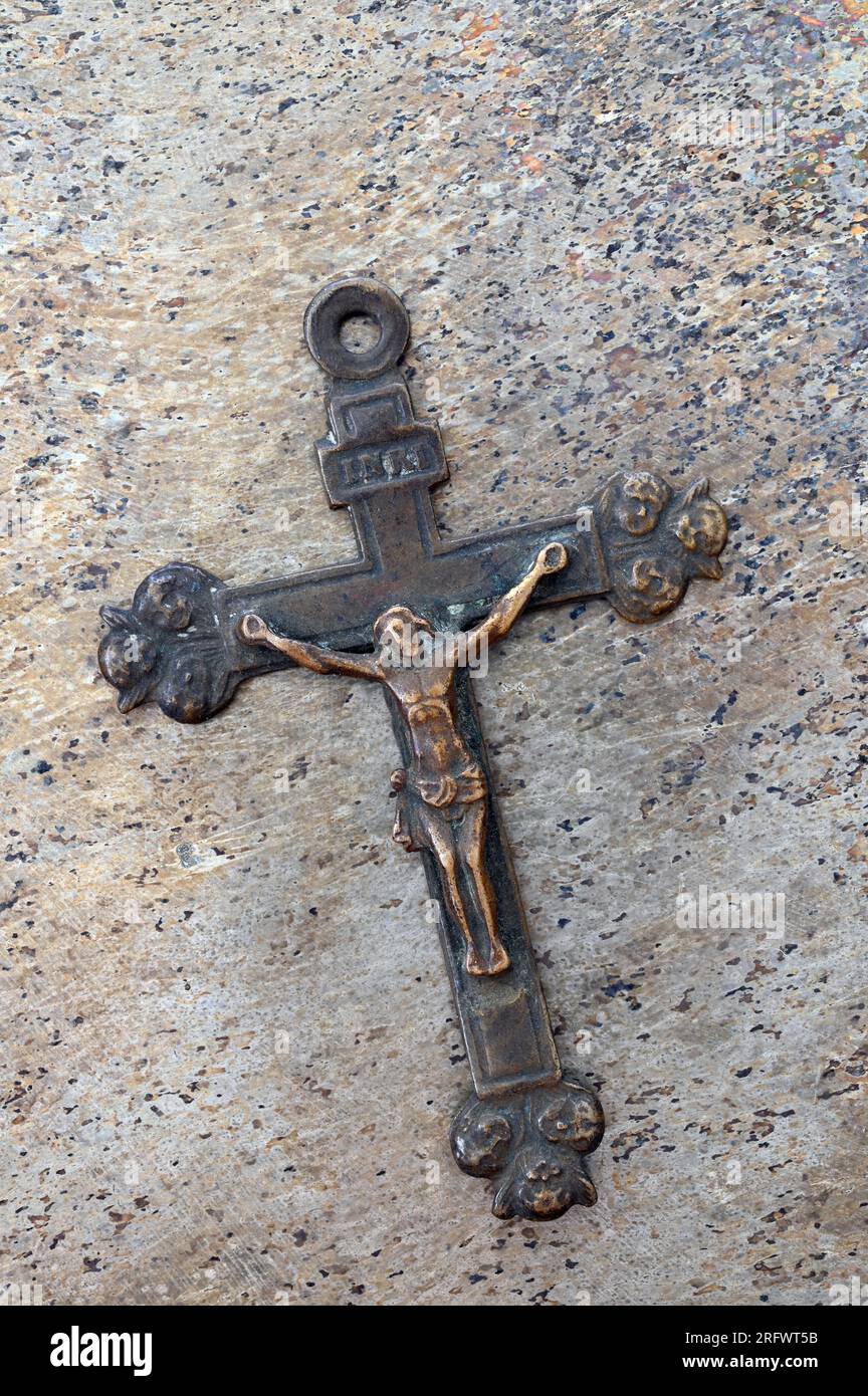 Used antique brass crucifix with rubbed Jesus Christ on it lying on ...
