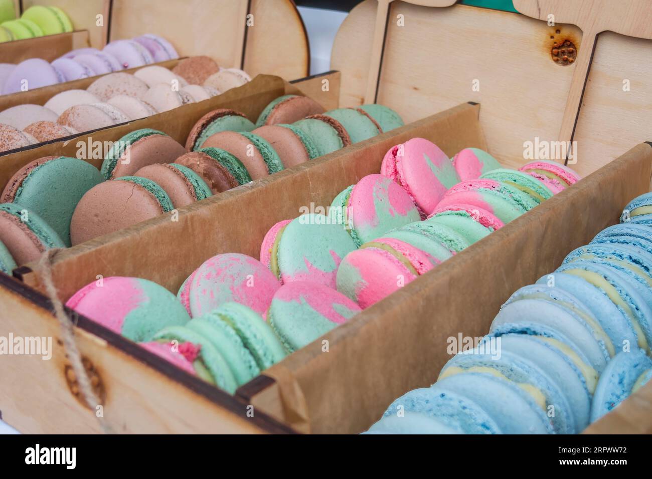Tasty homemade macaroon sweets assorted in the wooden boxes. Selective ...