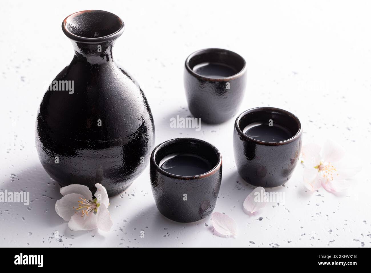 Special Japanese sake with pink blooming flowers. Method of serving ...