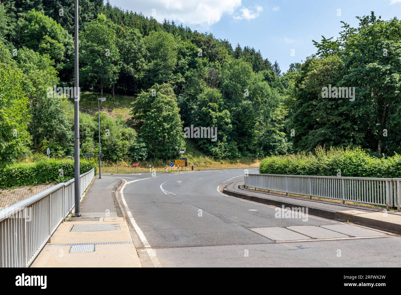 Empty country road with an intersection with traffic signs in ...