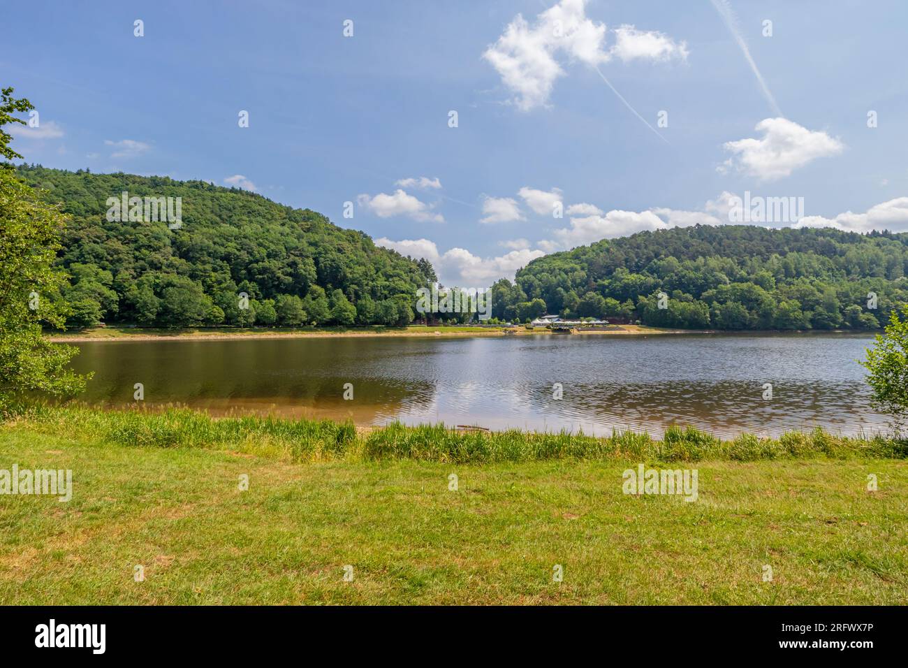 Landscape of Stausee Bitburg reservoir lake, calm water, mountains with ...