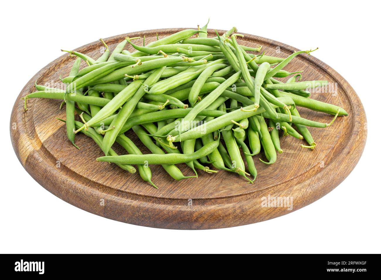 Green beans on a round cutting board isolated in white background ...