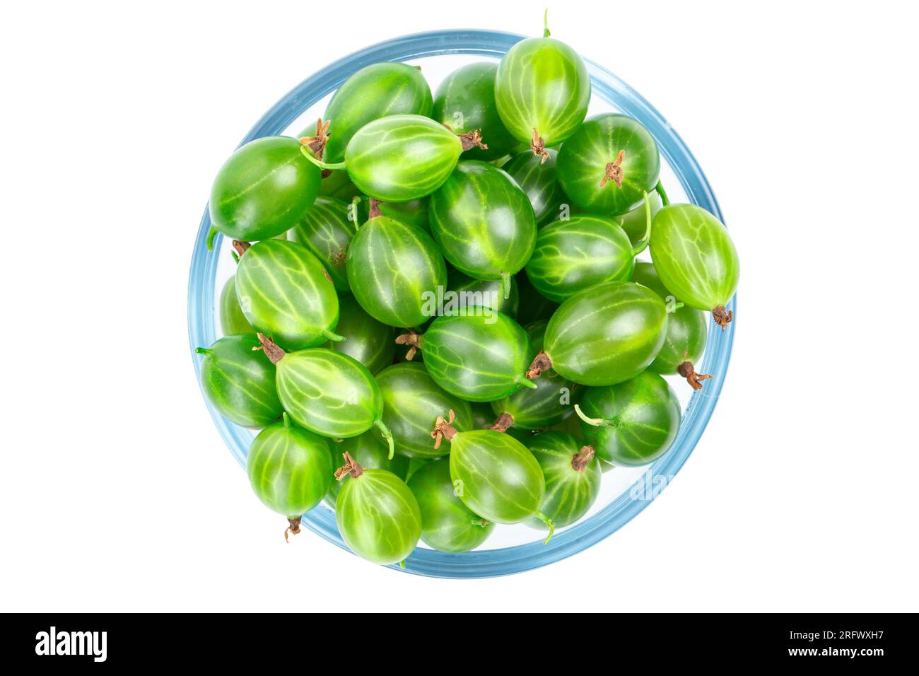 Ripe gooseberry in a glass plate of berries isolated on white ...