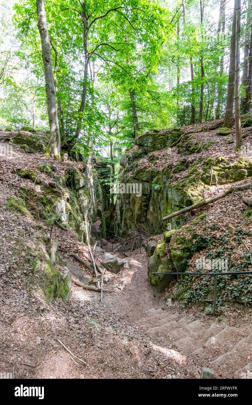 Stairs descending with metal railing between rock formations on hiking ...