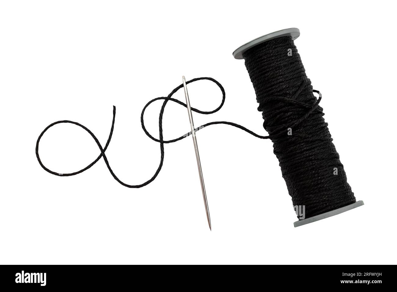 Plastic spool with black synthetic threads close-up. Needle and thread ...