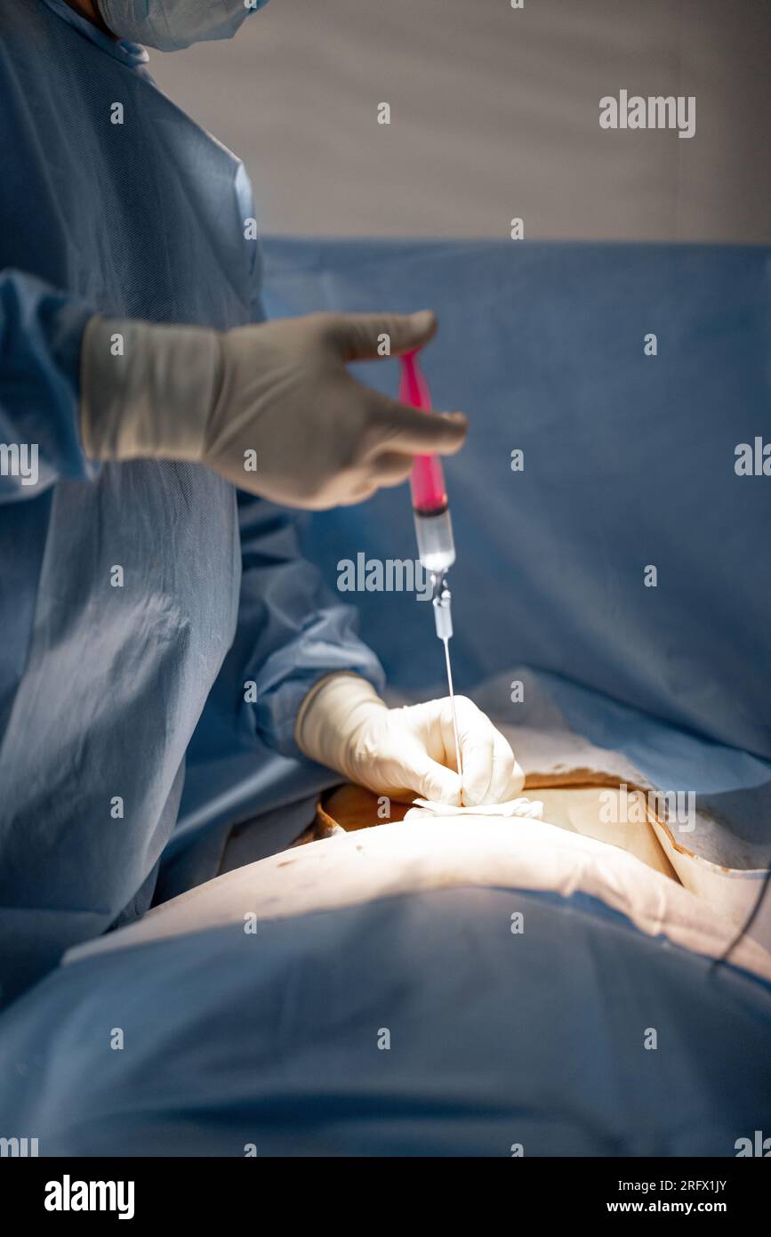 Surgeon makes an injection during an operation Stock Photo - Alamy