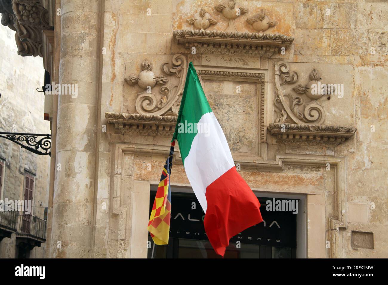 An Italian flag at a store front in the historical center of Lecce ...