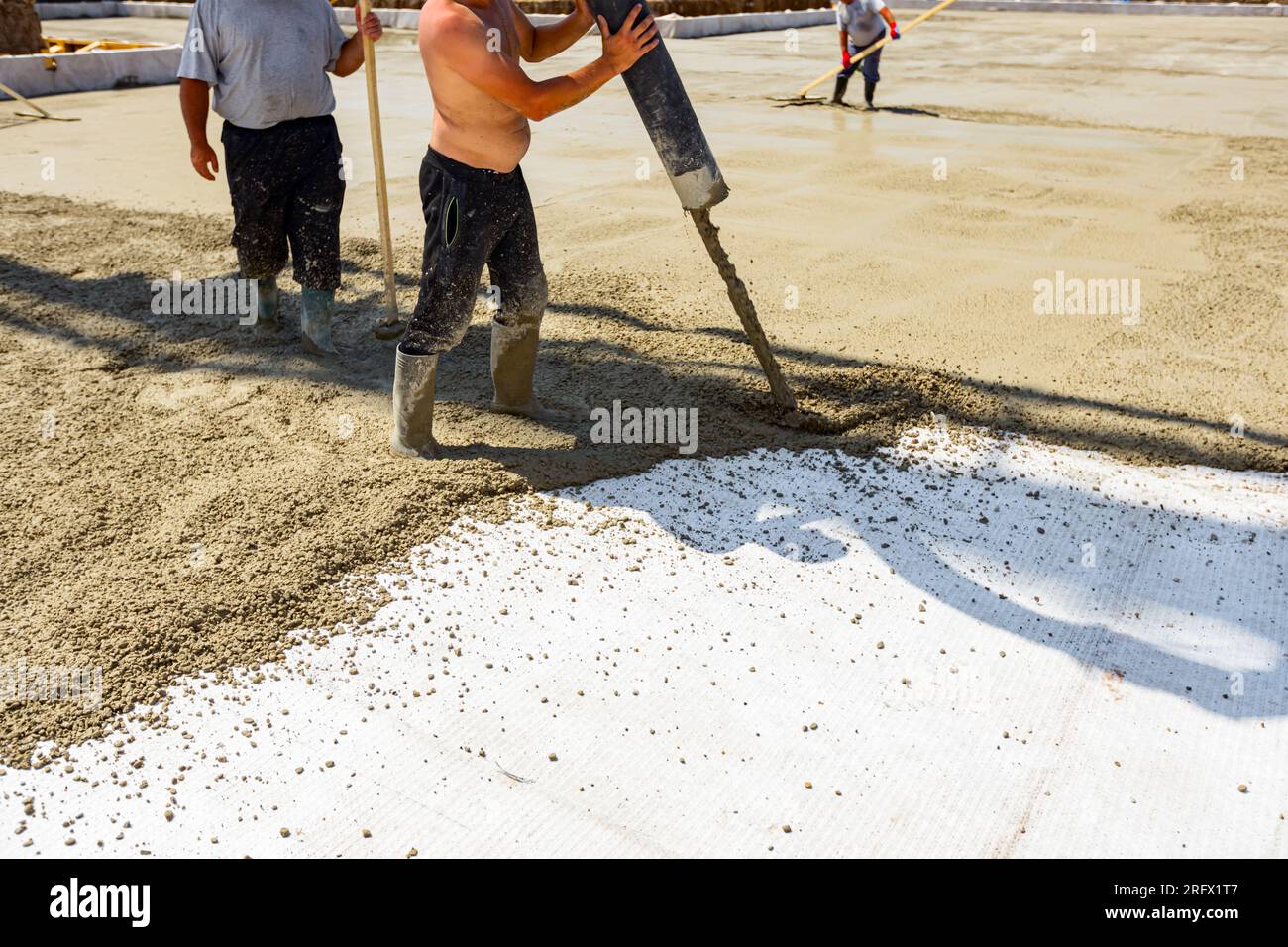 Construction worker is directing the pump tube on right direction ...