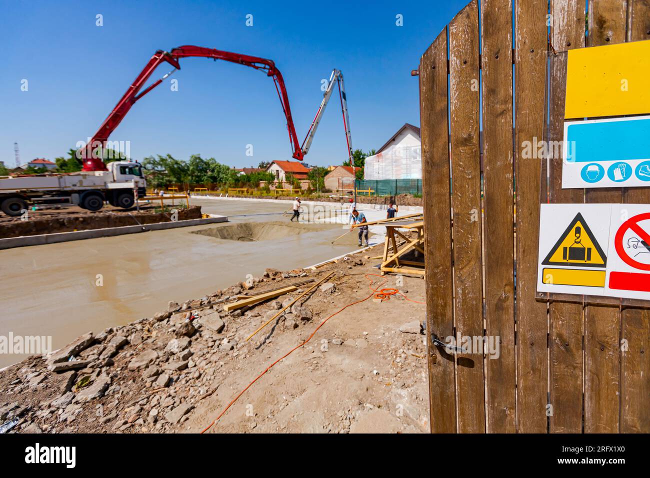 Open door made of wooden planks with warning signs on it, site entrance ...