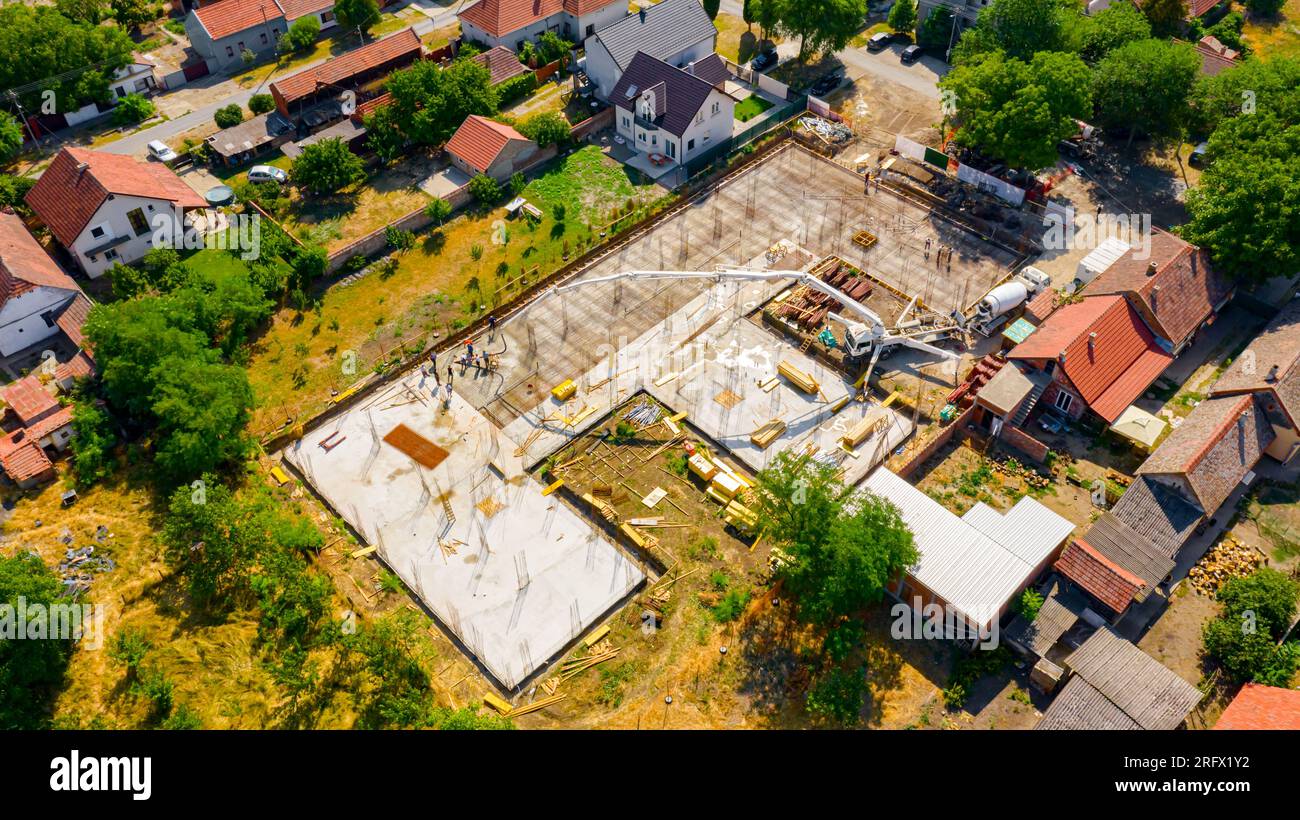 Aerial view construction worker is directing the pump tube as pouring ...