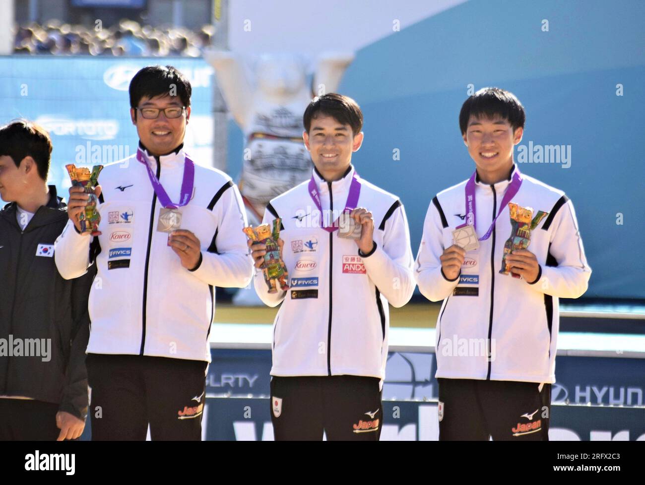 (L-R) Takaharu Furukawa, Junya Nakanishi and Fumiya Saito of Japan celebrate during an award ...
