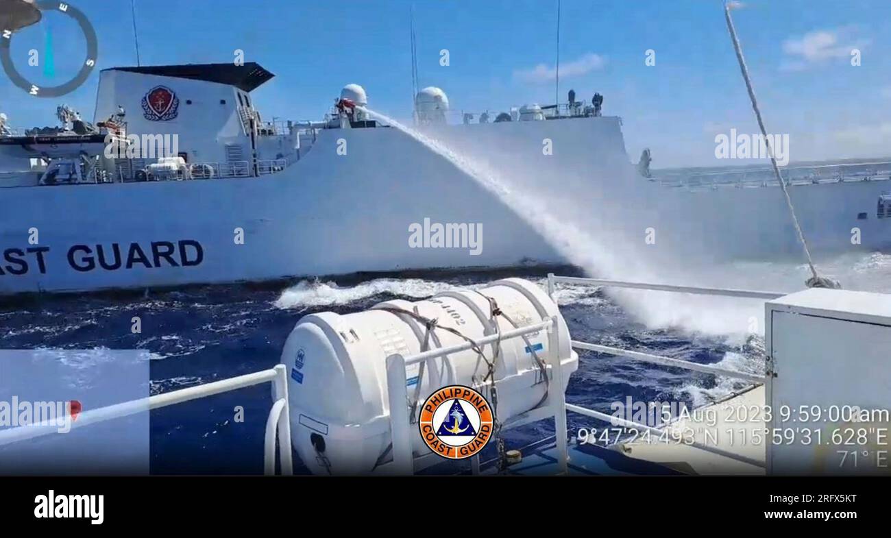 In this handout photo provided by the Philippine Coast Guard, a Chinese coast guard ship uses ...