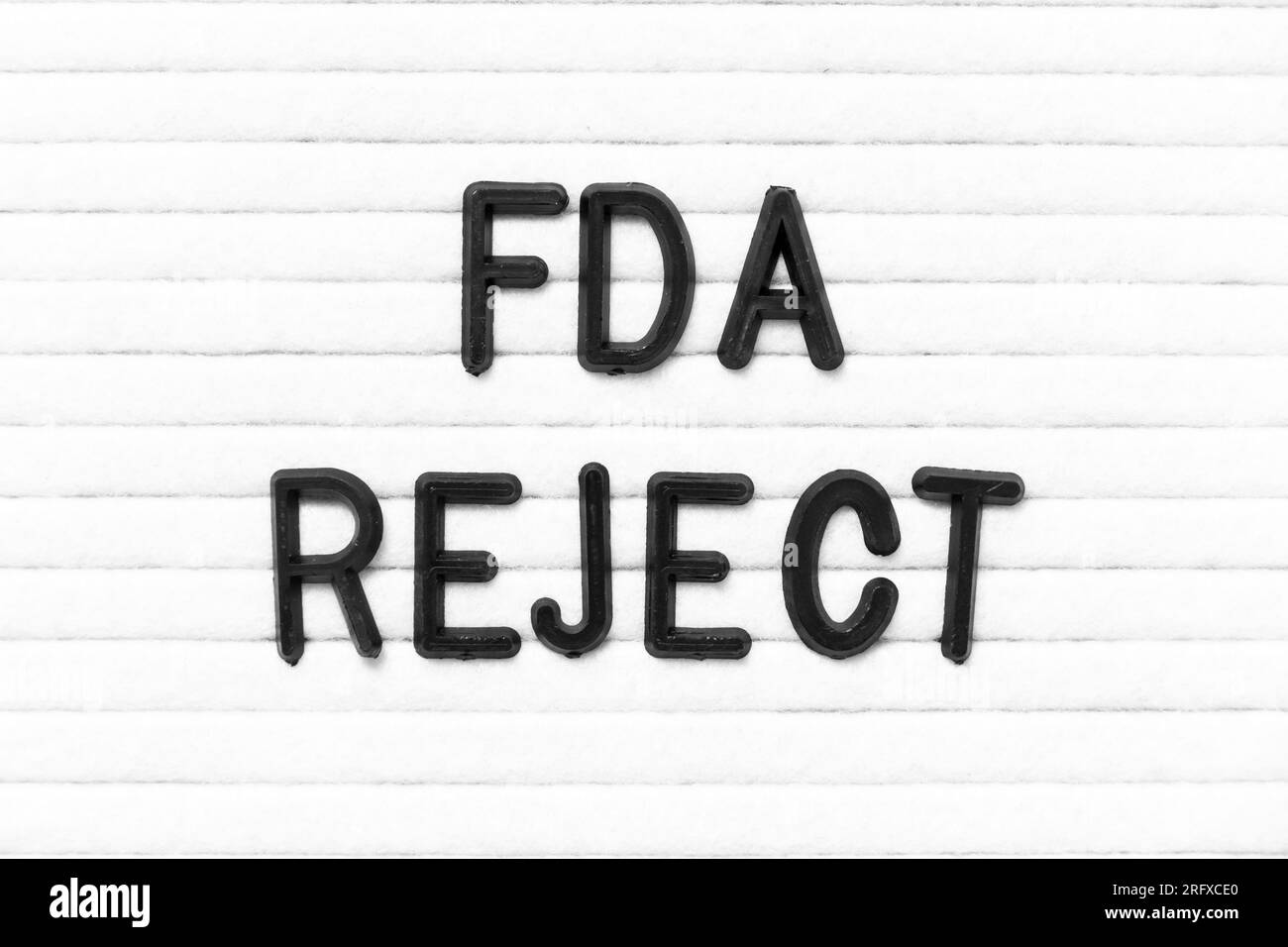 Black color letter in word FDA reject on white felt board background ...