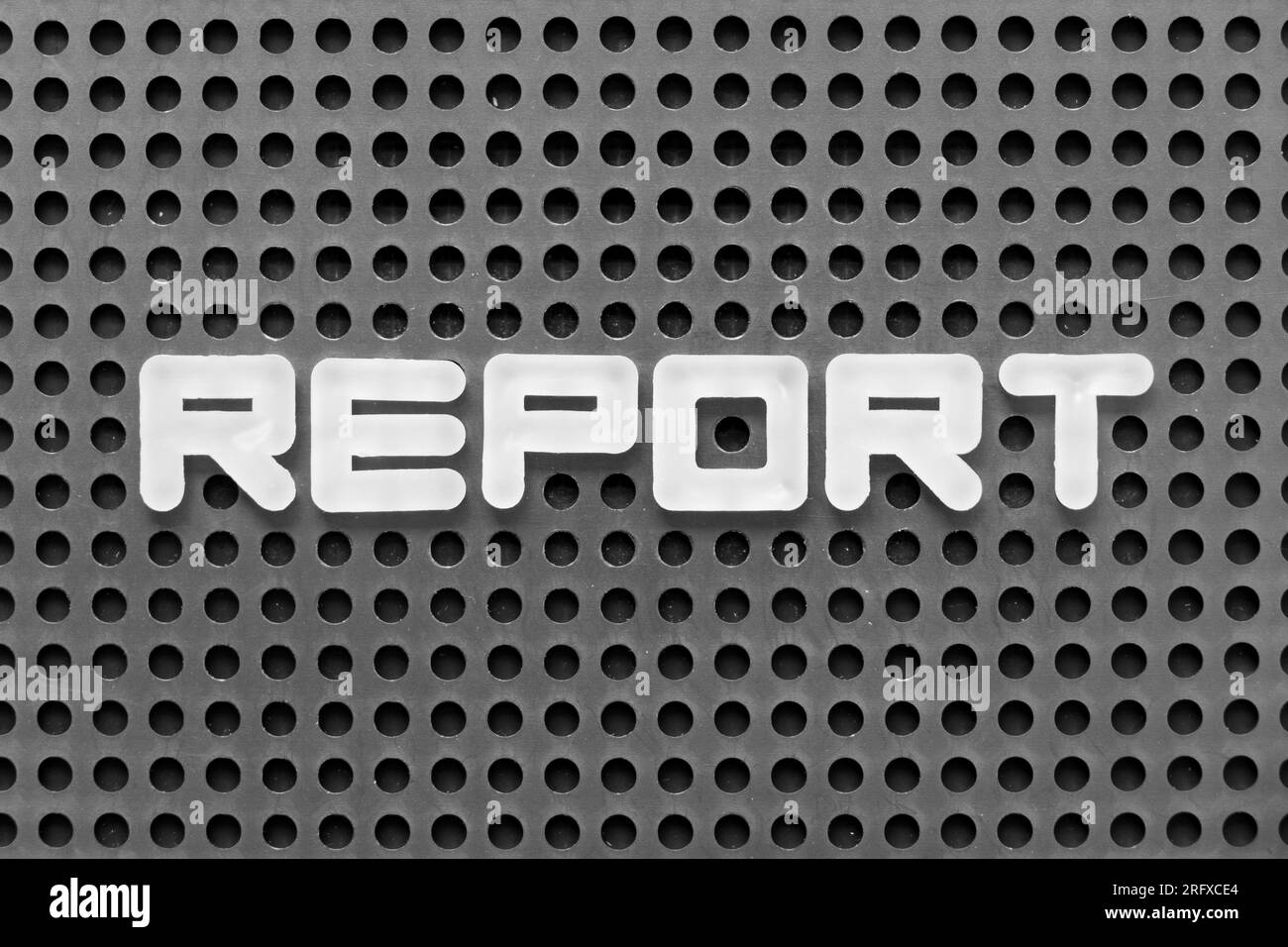 White alphabet letter in word report on black pegboard background Stock ...