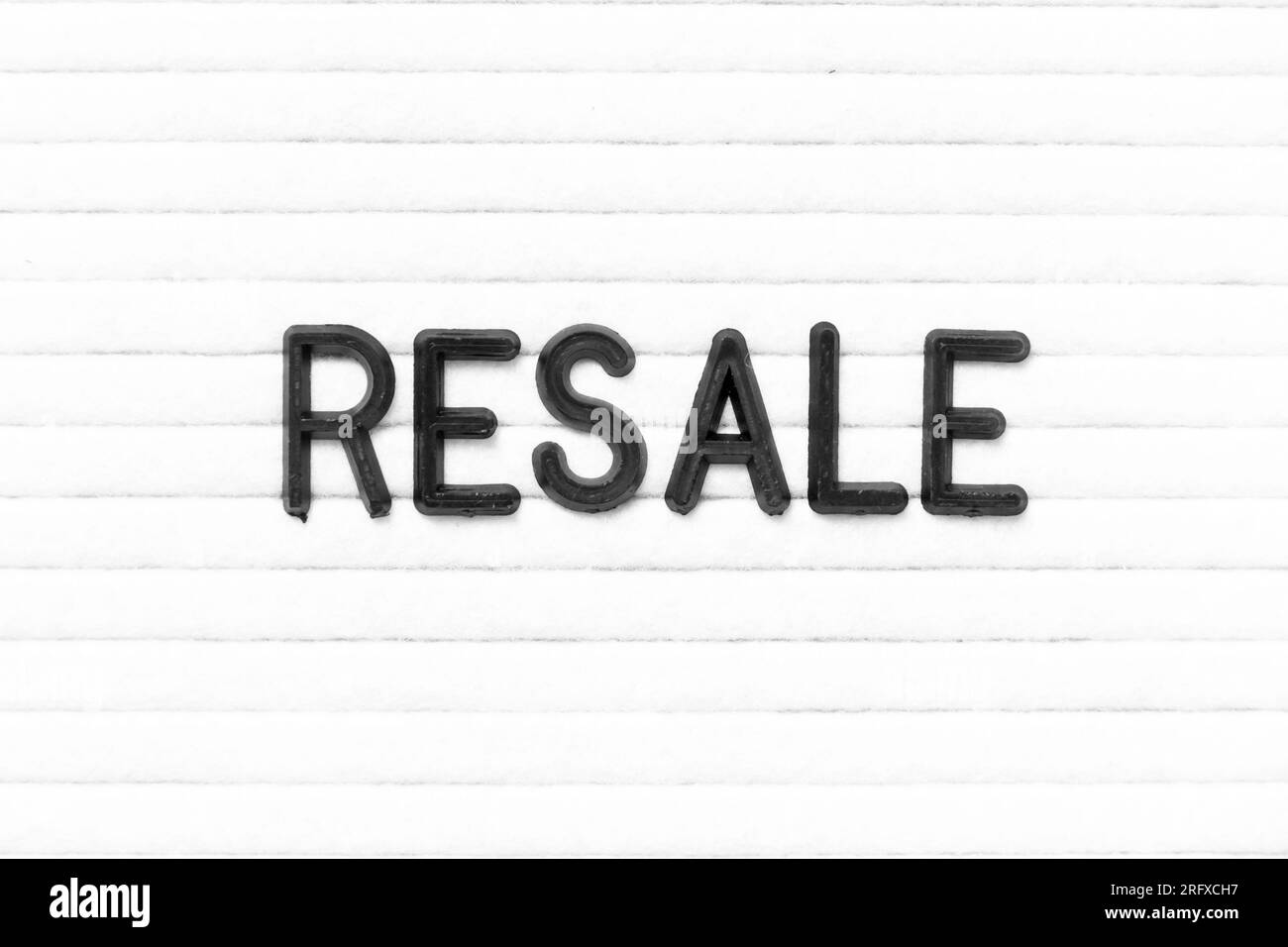 Black color letter in word resale on white felt board background Stock ...