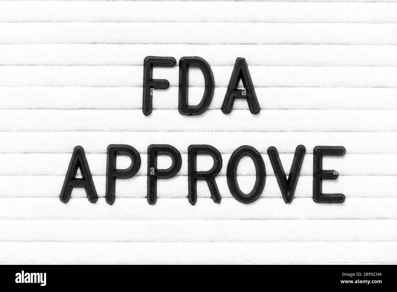 Black color letter in word FDA approve on white felt board background ...