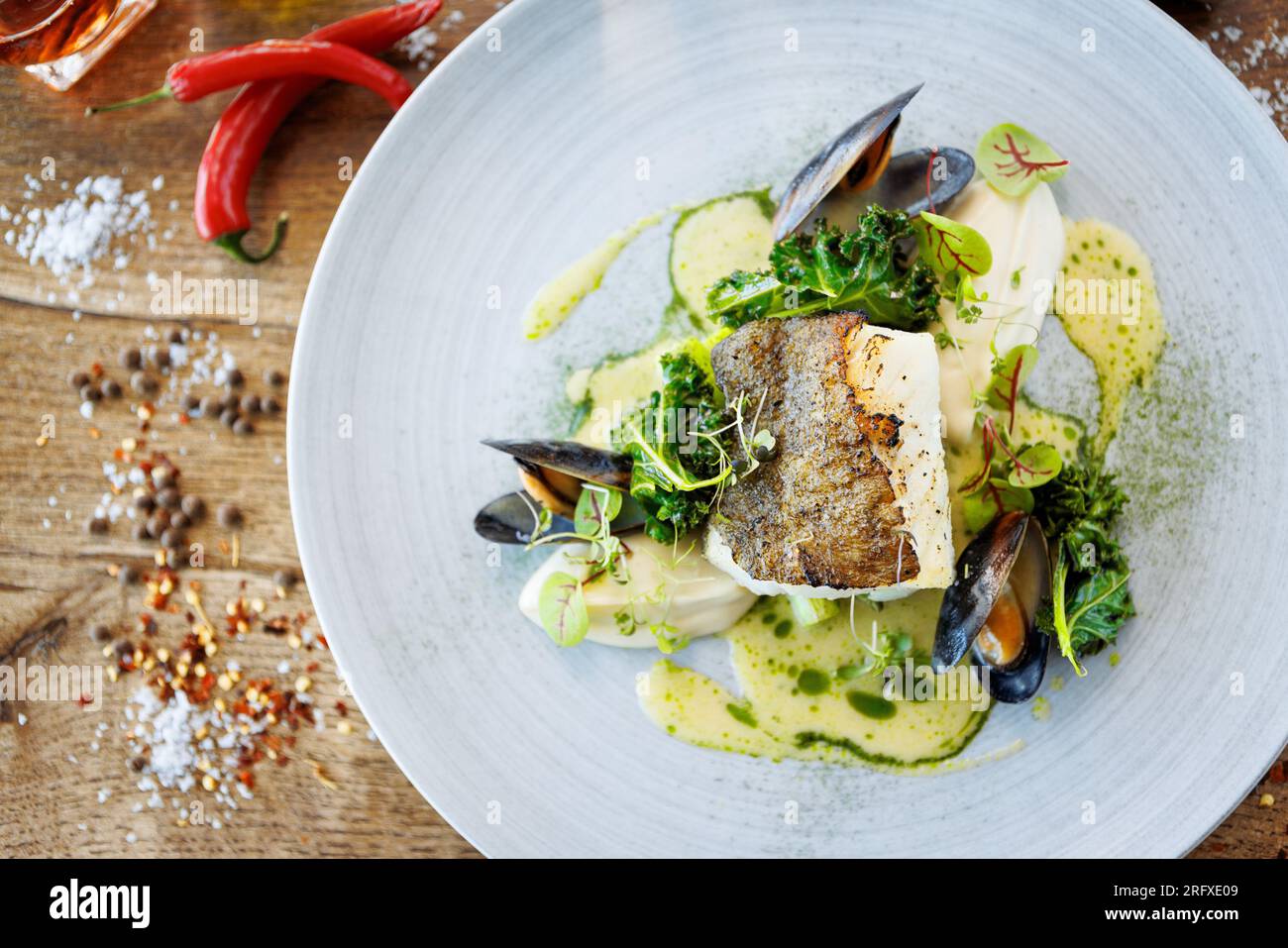 Cod fillet with cauliflower cream, asparagus, clam-wine sauce and ...