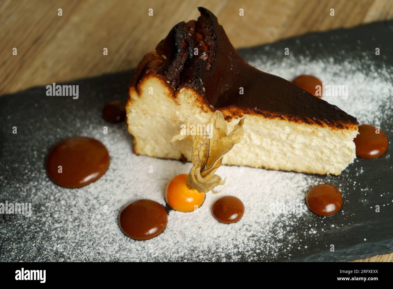 Basque burnt cheesecake with raspberry puree Stock Photo - Alamy