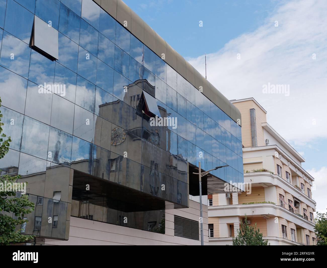 Dom vojske (House of the Army) clock tower reflects in window of nearby ...