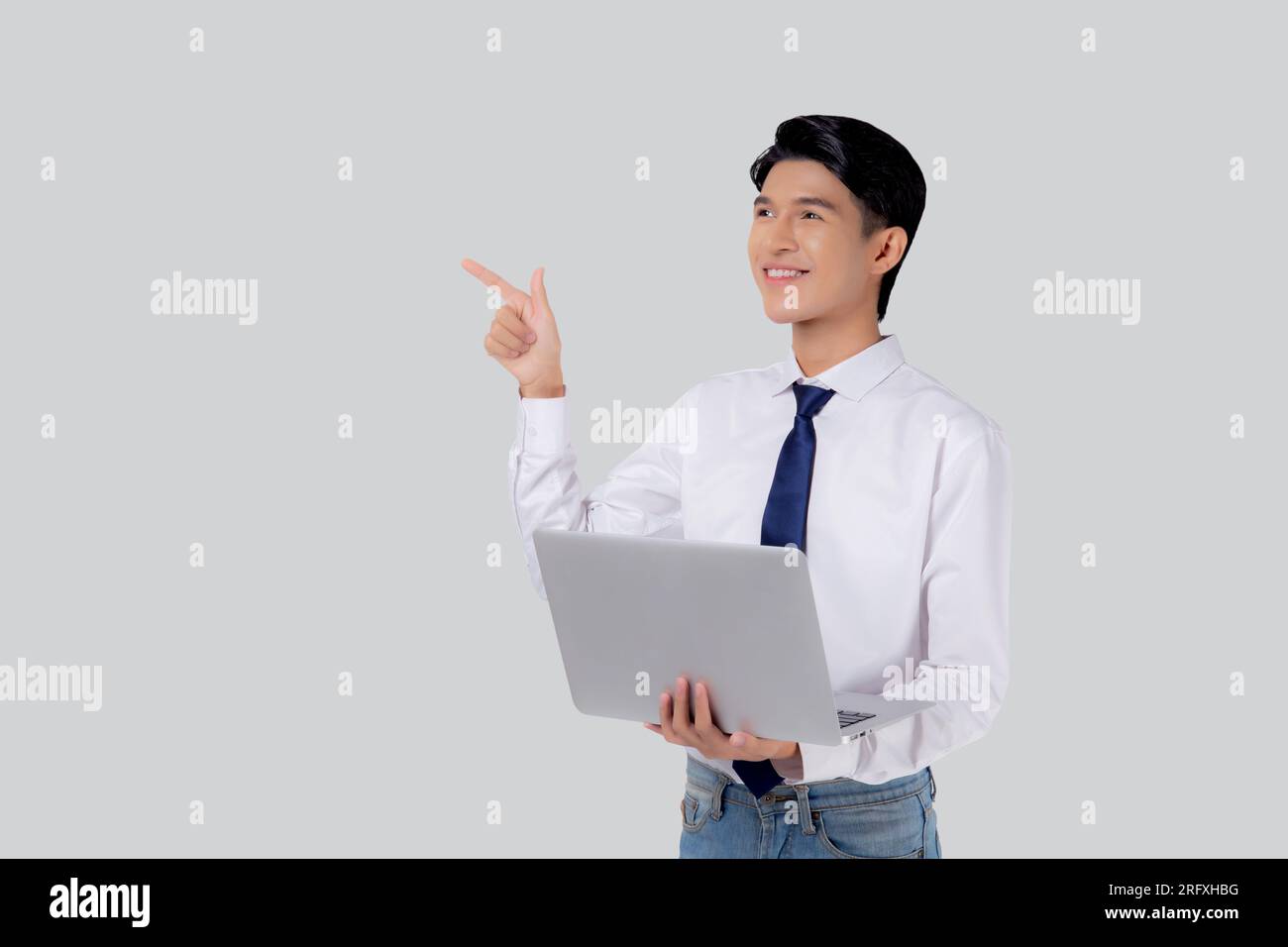 Portrait young asian business man standing work on laptop computer to ...