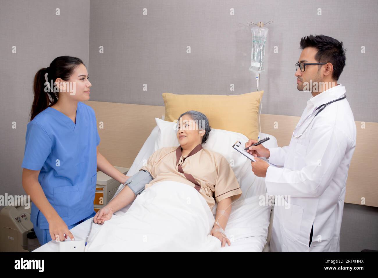 Doctor checkup and diagnostic while nurse measuring blood pressure with ...