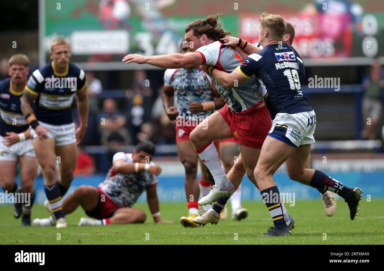 Leigh Leopard's Rob Mulhern is tackled by Leeds Rhino's James McDonnell ...