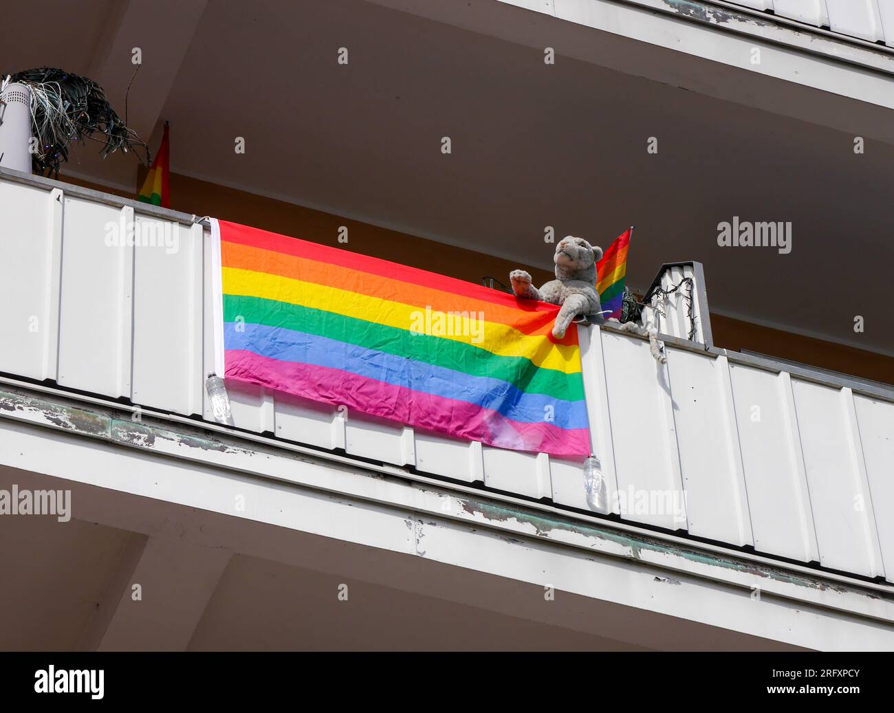 A rainbow flag hanging from balcony Stock Photo - Alamy