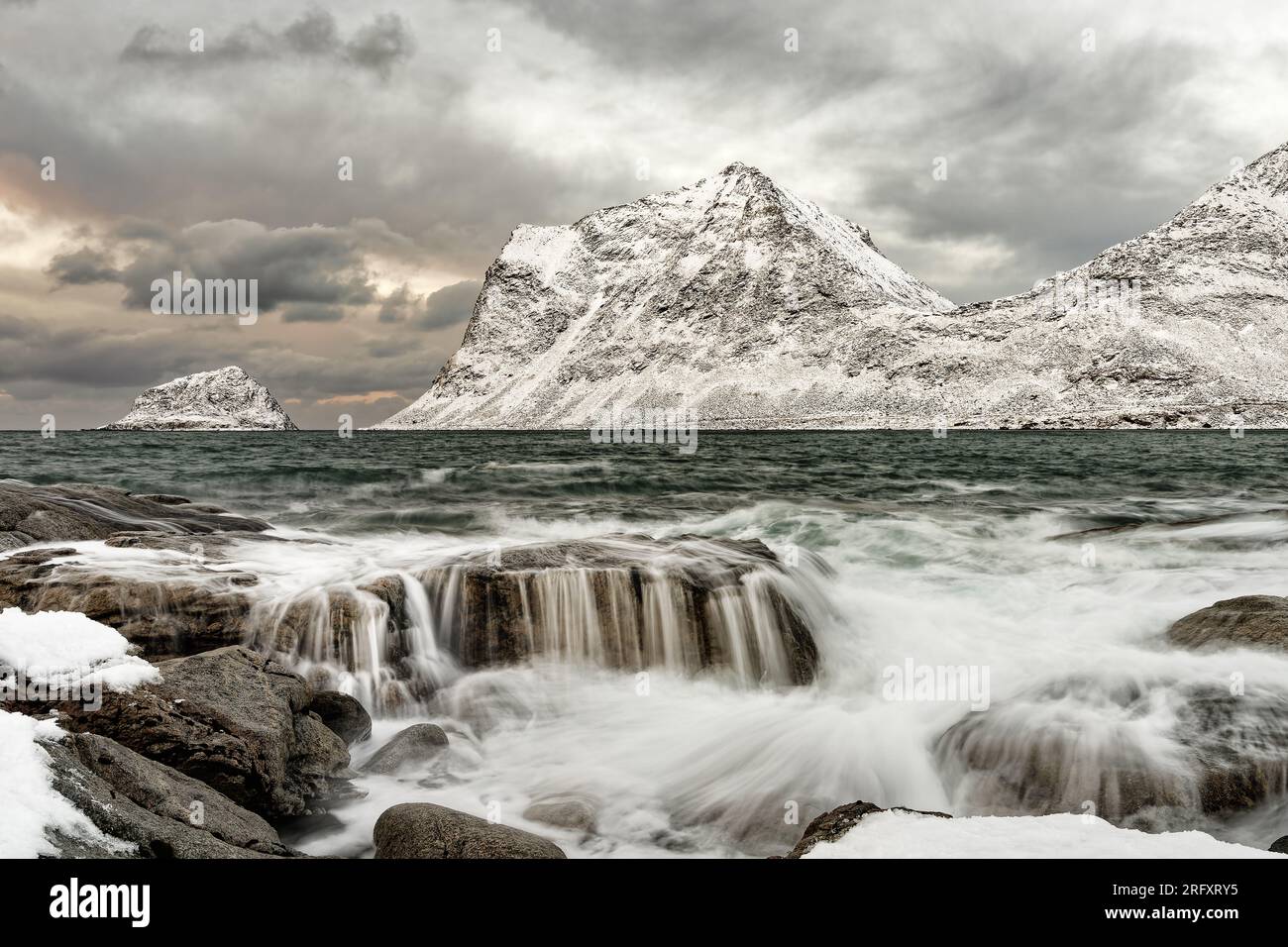 Coastal landscape in winter with water movement, waves pouring over ...