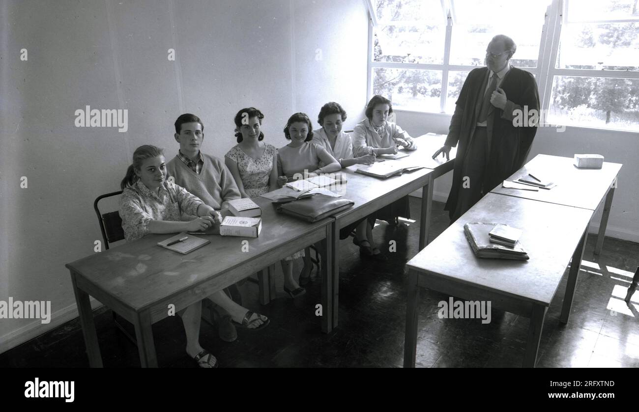 1950s, historical picture, young students sitting in a line at desks in ...