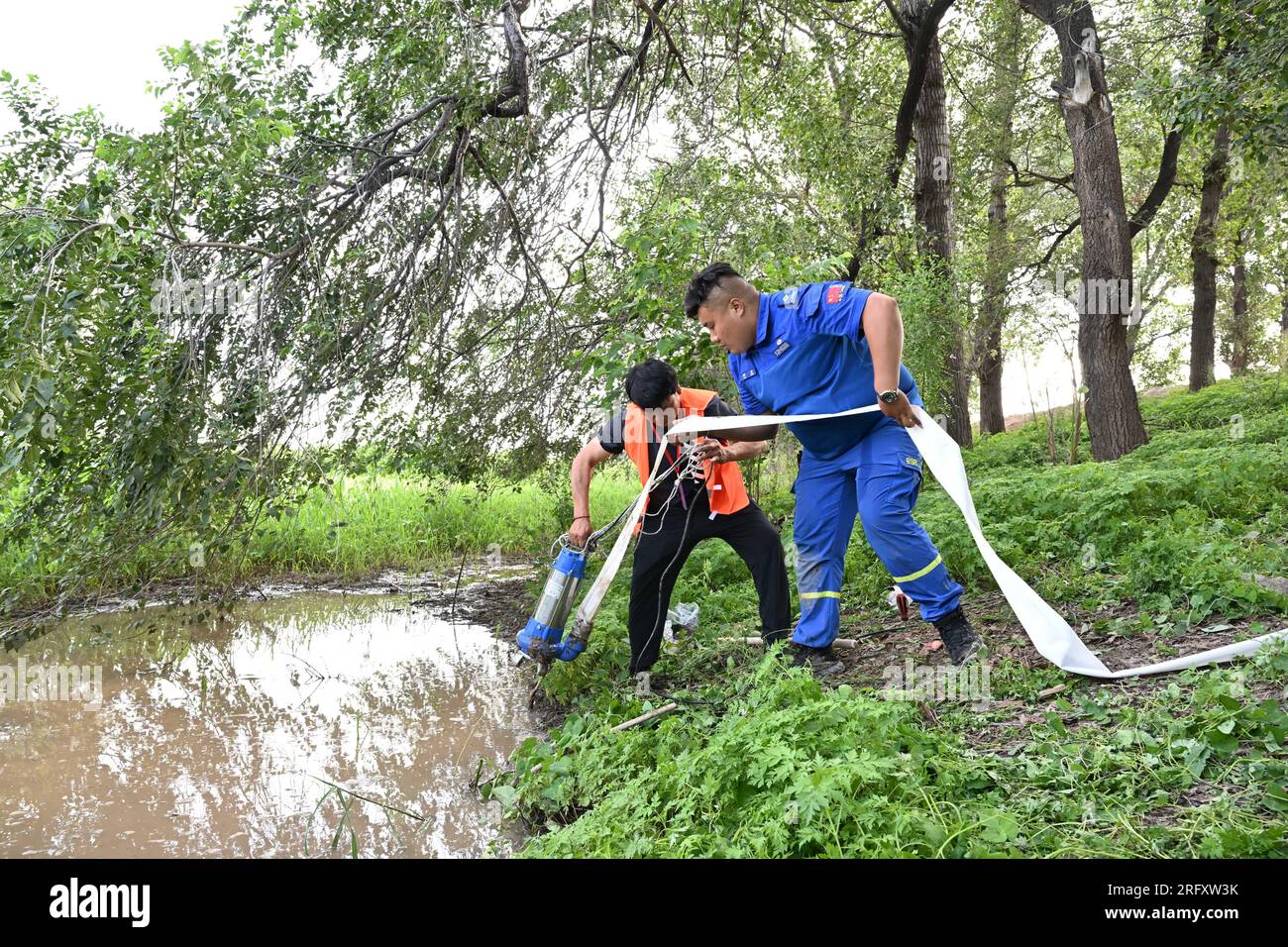 Tianjin. 6th Aug, 2023. Emergency workers reinforce a dike along the ...
