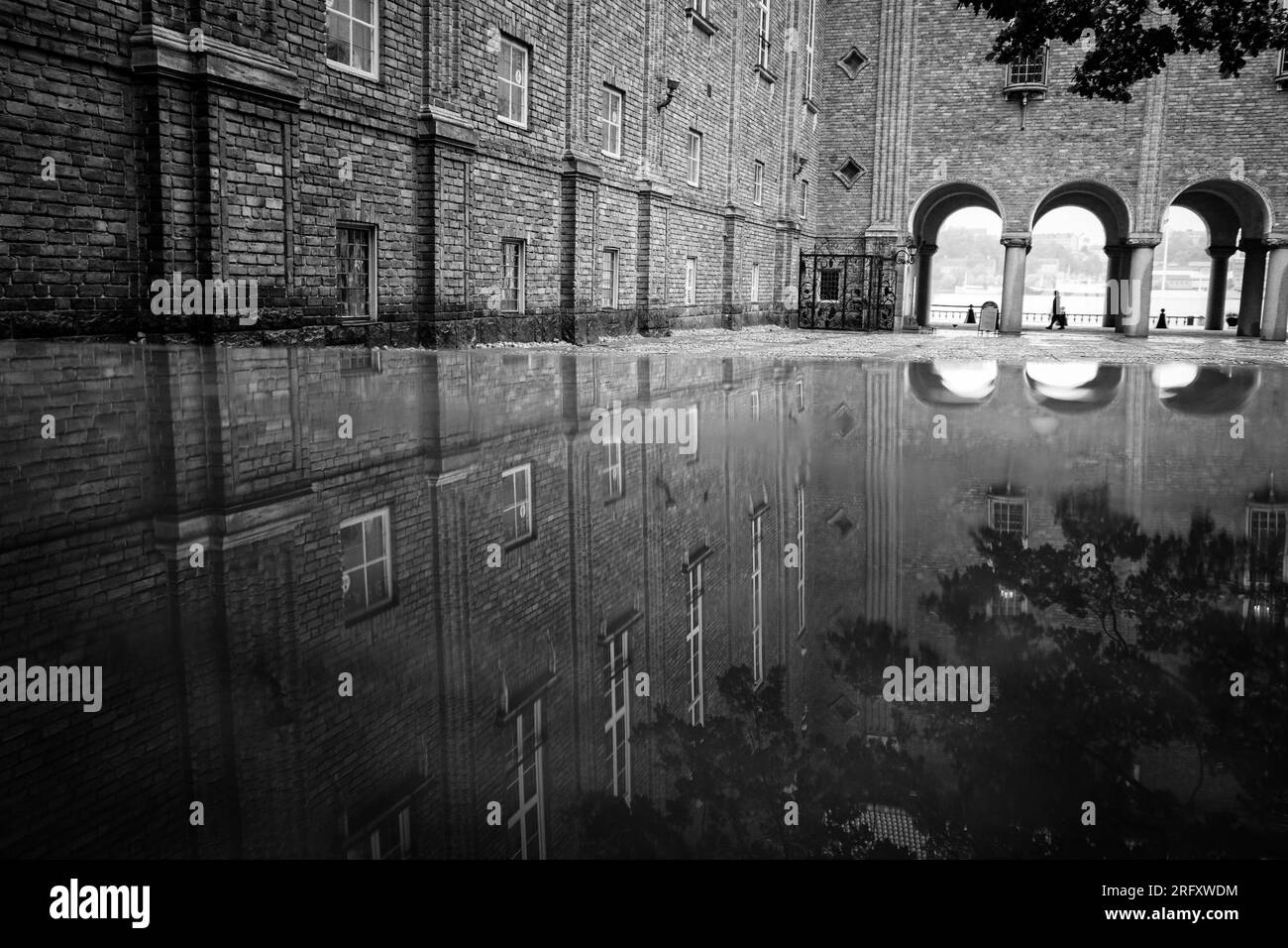 a wet courtyard to large brick building Stock Photo - Alamy