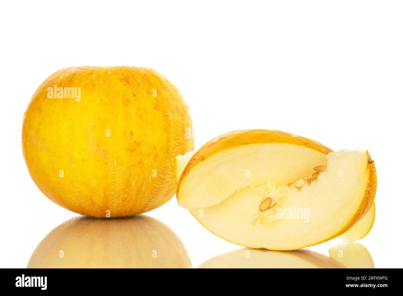 One yellow melon with one slice, macro, isolated on white background ...