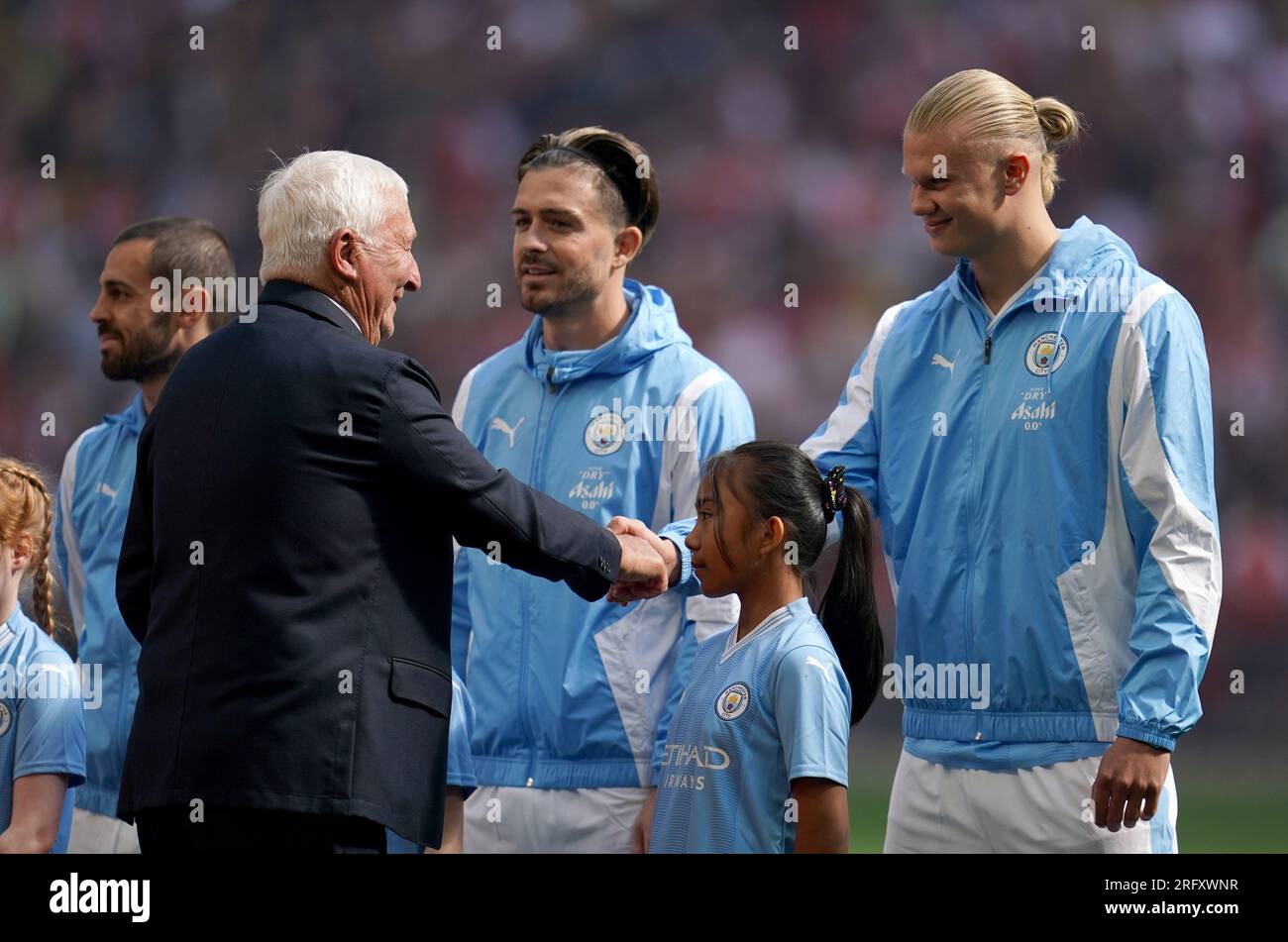 Former Manchester City player Mike Summerbee shakes hands with Erling ...