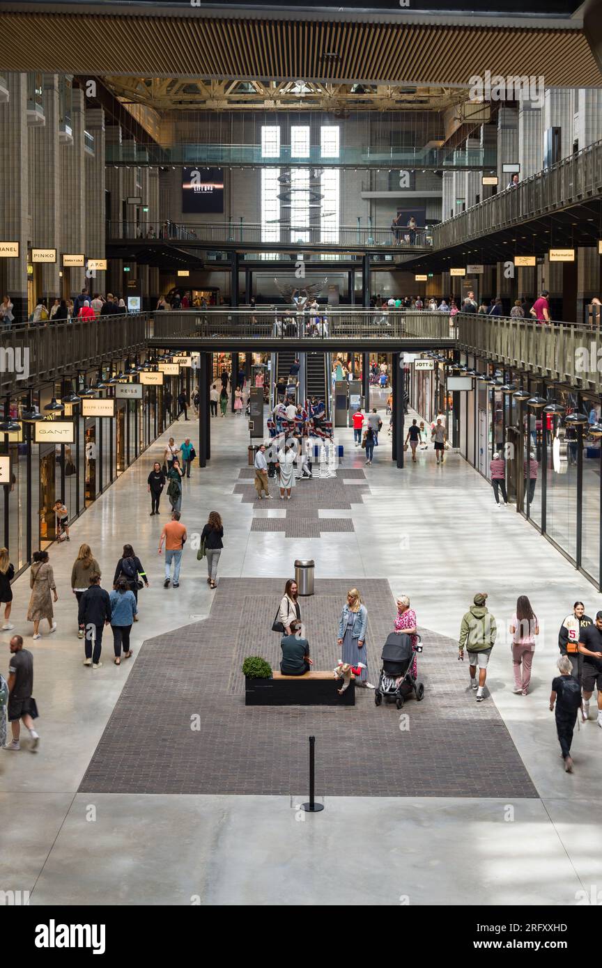 Interior of Battersea Power Station showing people walking past retail ...