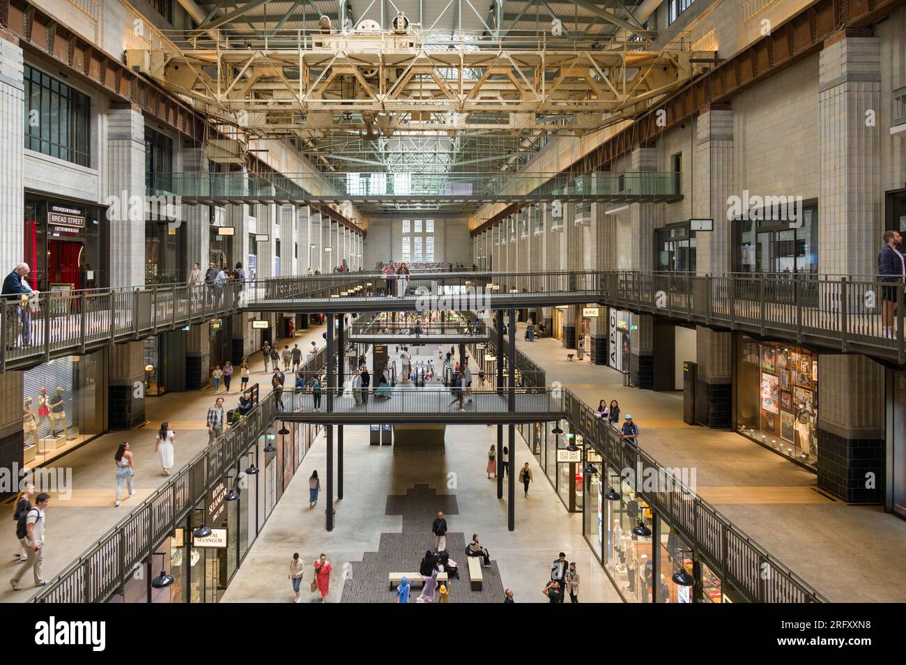 Interior of Battersea Power Station showing people walking past retail ...