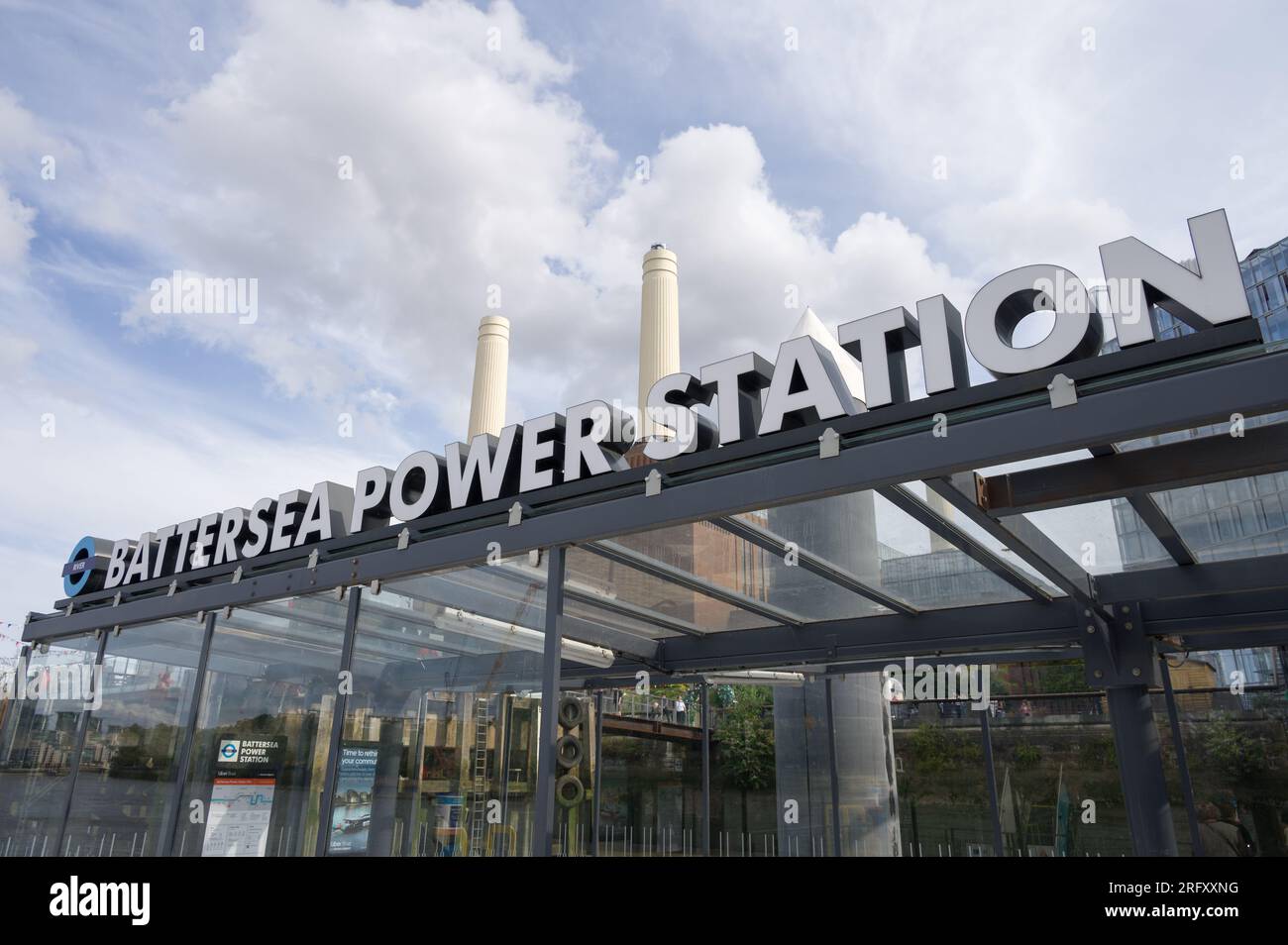 Battersea Power Station river ferry terminal sign with chimneys in ...