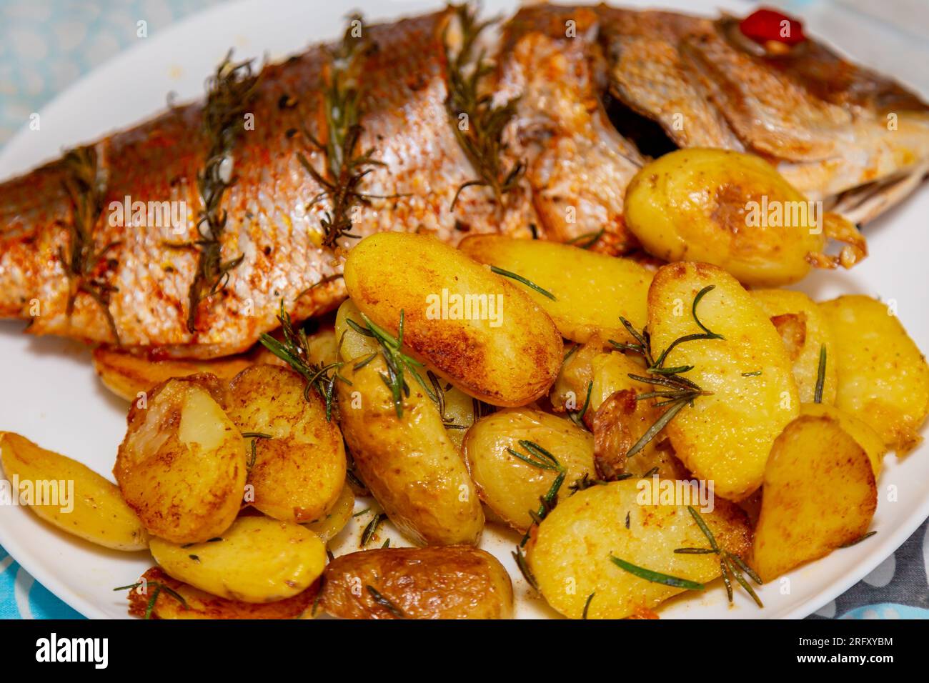 Traditional roast snapper fish with rosemary and sautéed potatoes Stock ...