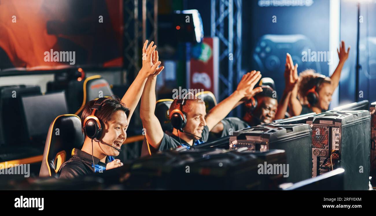 Celebrating success. Team of happy proffesional cyber sport gamers ...
