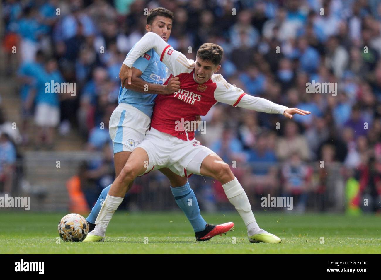 Arsenal's Kai Havertz, right, challenges for the ball with Manchester ...