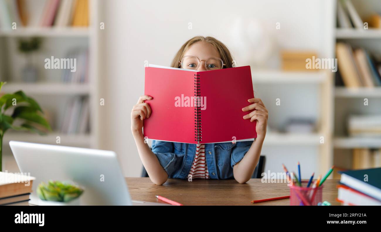 child; happy; remote; book; success; homework; caucasian; smiling ...