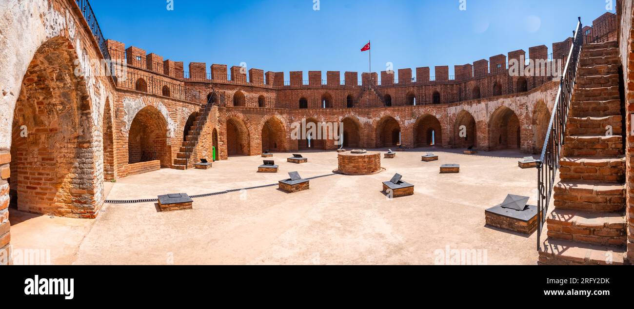 View of Alanya Red Tower in Antalya with orenge bricks, on bright blue ...