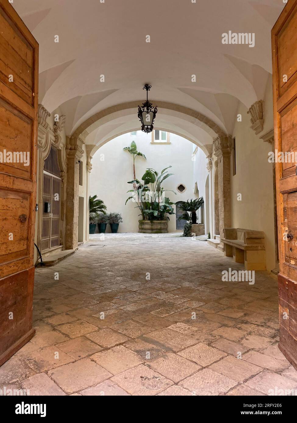 Courtyard seen through an arched passage in the historical center of ...