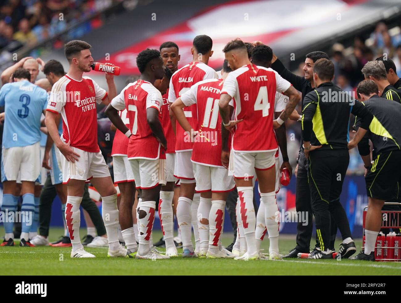 Arsenal's Declan Rice drinks from a Prime bottle during a break in play ...