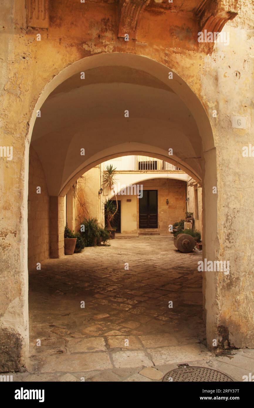 Courtyard seen through an arched passage in the historical center of ...