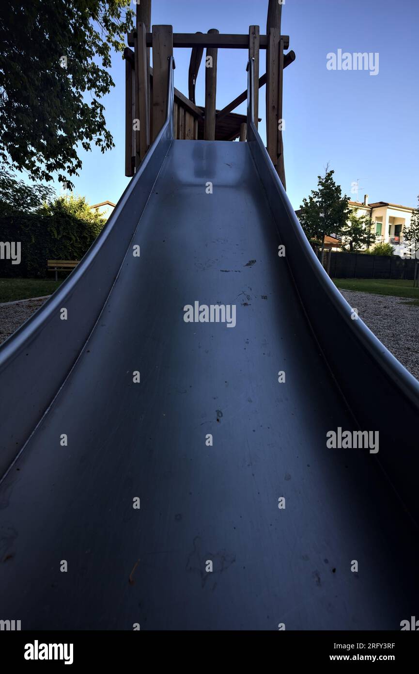 Slide in a playground seen from one end and up close Stock Photo - Alamy